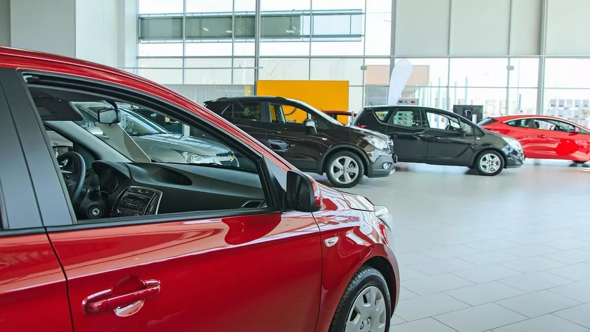 Several new cars at dealership salon.