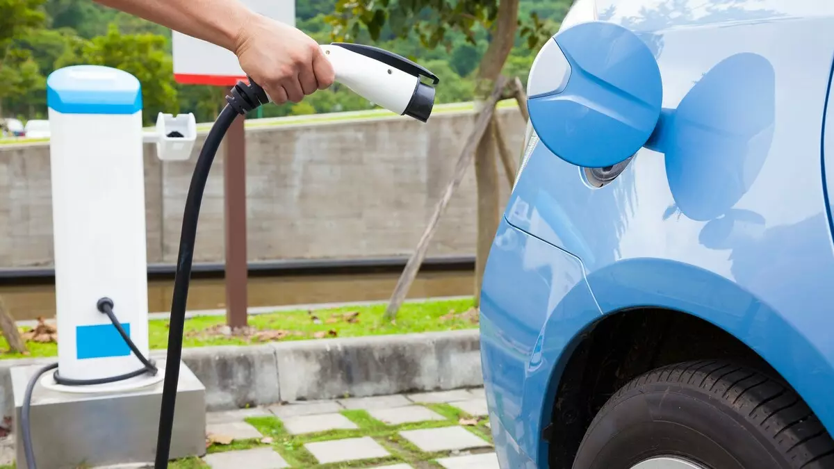 Hand Holding Plug for Chargeing Of An Electric Car in Parking Spa