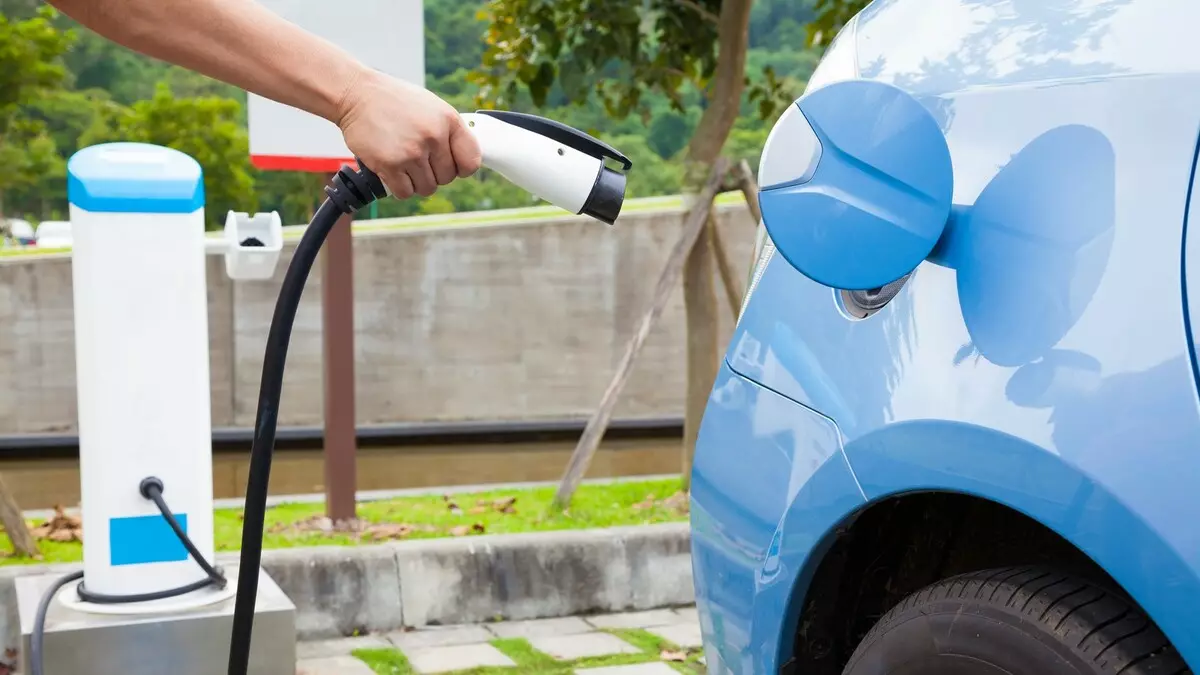 Hand Holding Plug for Chargeing Of An Electric Car in Parking Spa